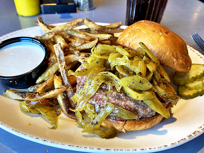 Caramelized onions cascade over this burger like a savory waterfall, proving that sometimes the best toppings are the most straightforward.