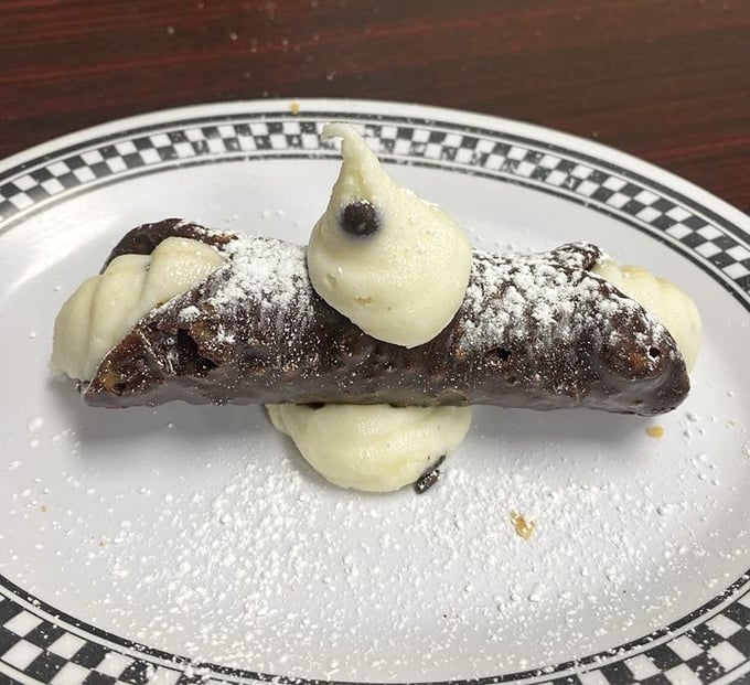 The perfect sweet finale &ndash; crisp pastry shell embracing sweetened ricotta and chocolate chips, dusted with powdered sugar.
