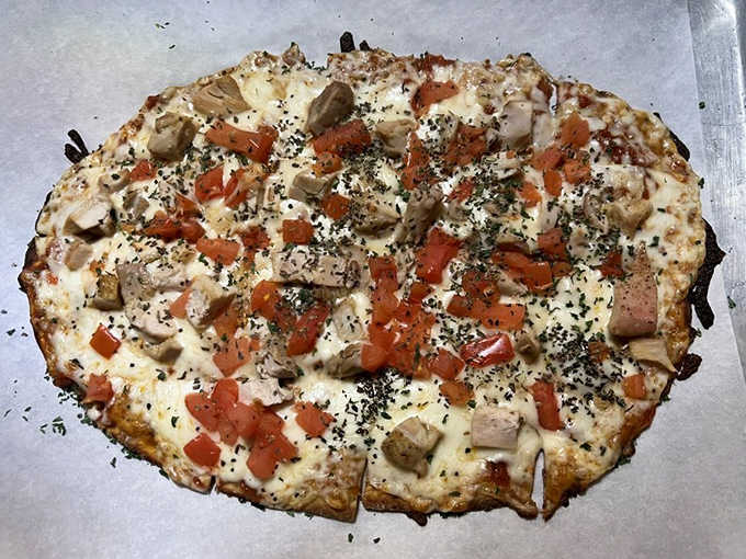 This chicken flatbread emerges from the kitchen like an edible stained glass window – a colorful array of toppings on perfectly baked crust.