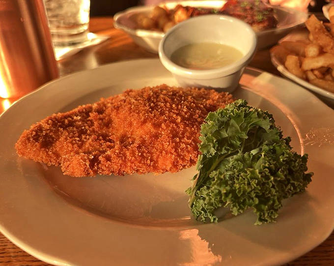 Golden-crusted chicken that shatters at first bite reveals juicy meat within &ndash; comfort food elevated beyond the ordinary by careful preparation.