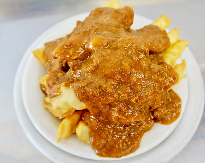 Golden crinkle-cut fries swimming in homemade chili and melted cheese&mdash;comfort food that speaks directly to your soul.