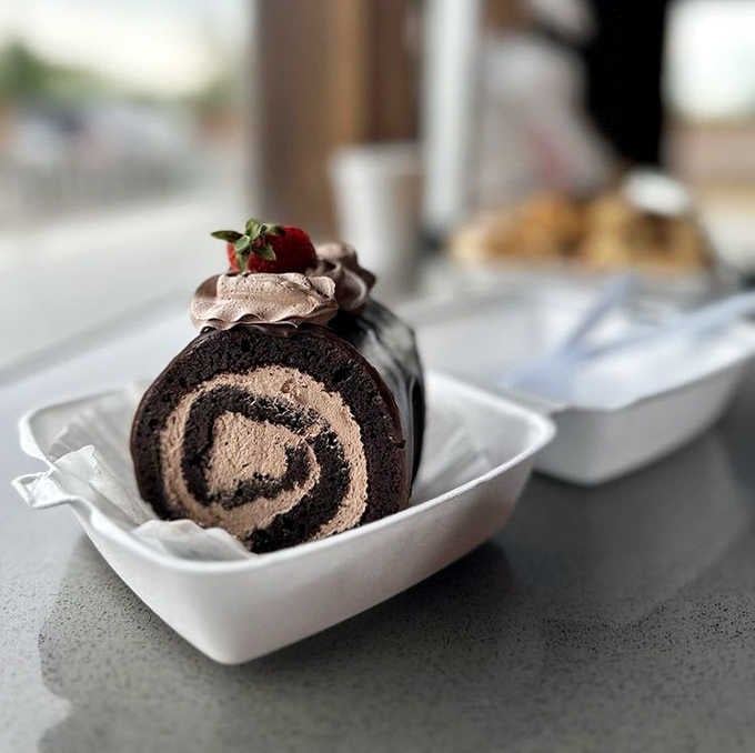 The chocolate raspberry cake offers a decadent alternative, with rich chocolate layers drizzled with vibrant raspberry sauce for a perfect flavor combination.