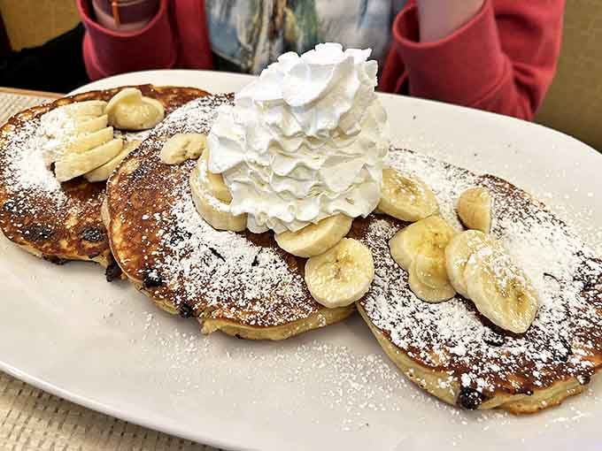 Chocolate chip pancakes with banana slices and a mountain of whipped cream &ndash; childhood dreams in adult portion sizes.