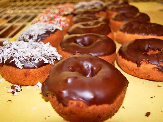 Chocolate-glazed donuts glistening under bakery lights like they're auditioning for a food magazine cover &ndash; and absolutely nailing the screen test.