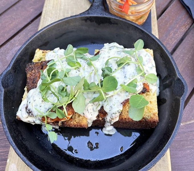 This isn't just cornbread &ndash; it's a canvas for fresh herbs and creamy sauce, elevating a simple side to memorable status.