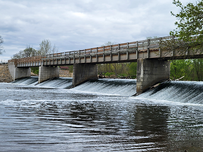 The dam's gentle cascade creates a hypnotic soundtrack that drowns out the modern world, inviting contemplation and wonder.