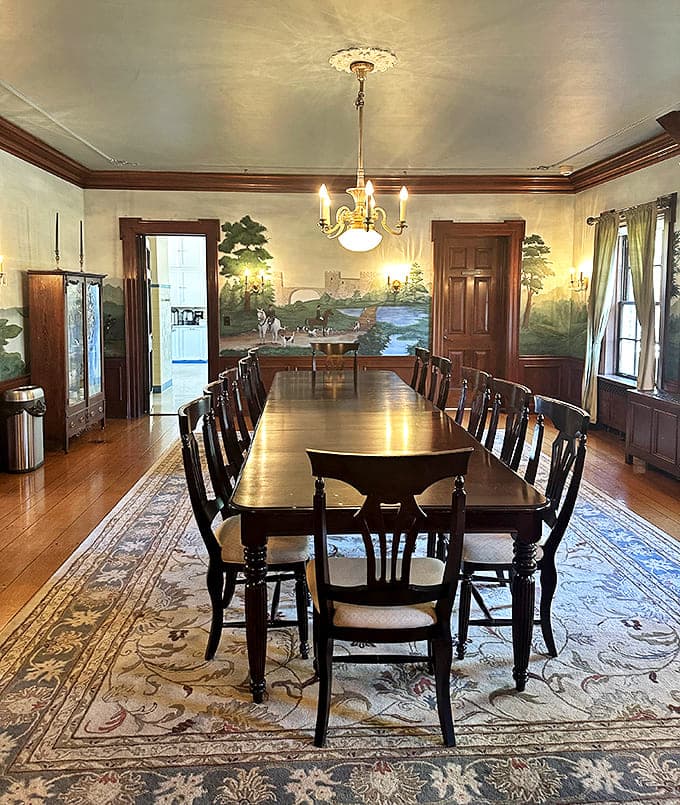 Dining Area: Imagine the dinner conversations that unfolded around this magnificent table, beneath pastoral murals that bring the outdoors inside.