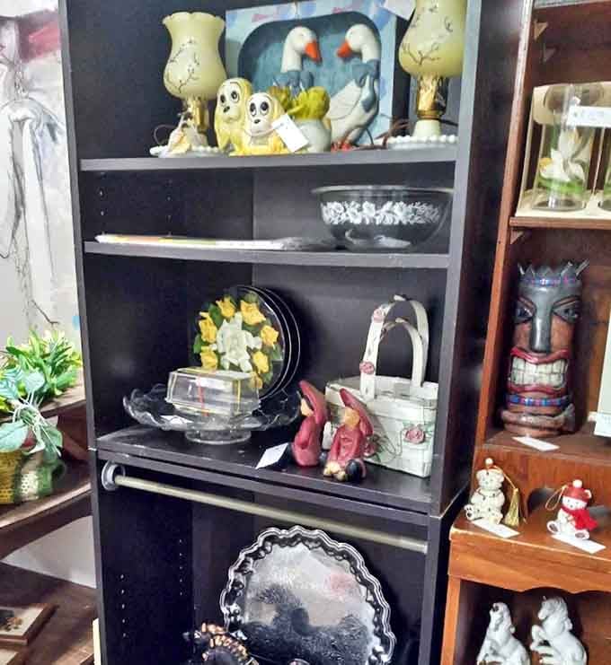 Little figurines meet face idols on this display shelf &ndash; a marriage of sacred and playful that only antique stores dare arrange.