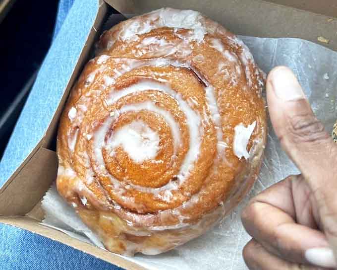 A spiral-shaped masterpiece that's essentially a warm hug in pastry form, with icing rivers flowing through cinnamon valleys.