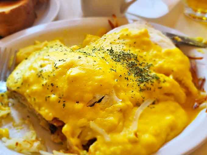 Hollandaise sauce cascading over perfectly poached eggs like a sunrise over Minnesota lakes &ndash; breakfast architecture at its finest.