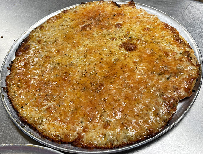 The "everything" pizza showcases Fricano's philosophy: quality ingredients arranged with care on that legendary thin crust.