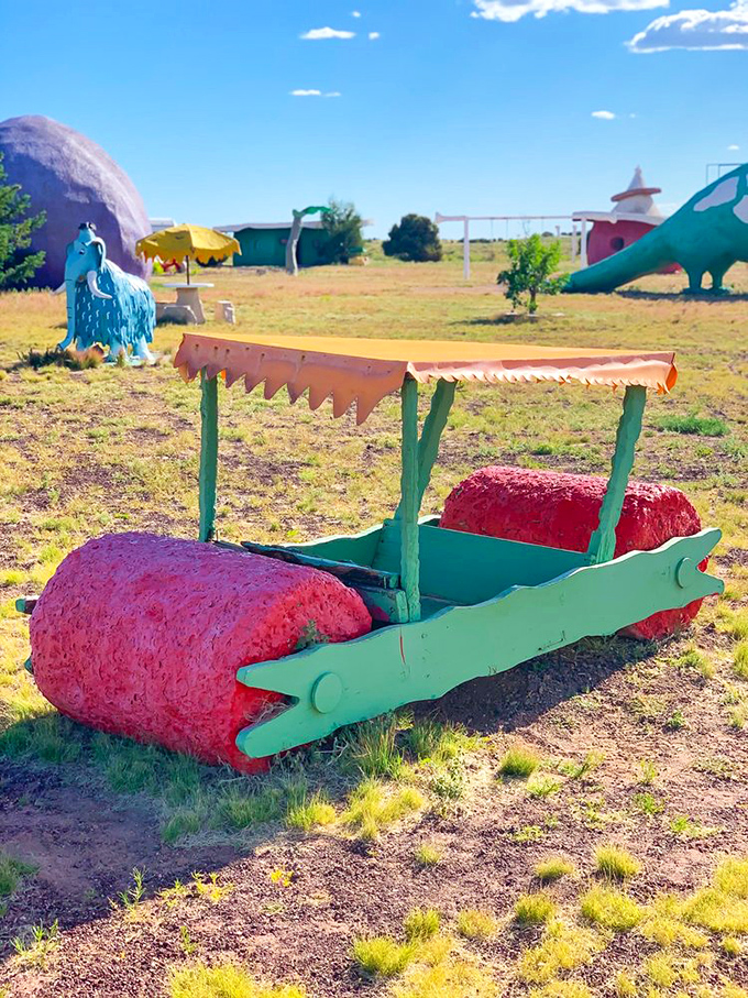 The famous Flintstone car sits ready for photo ops, its stone wheels and wooden top making modern vehicles seem downright boring.