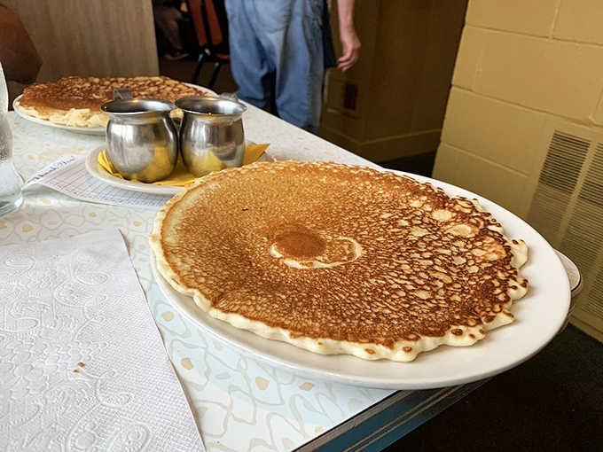 Fred's pancakes don't just hang over the edge of the plate – they practically need their own zip code.
