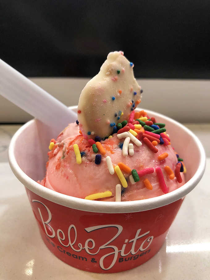 This scoop isn't just wearing sprinkles &ndash; it's dressed for the party your mouth is about to throw. The white chocolate shard is its fancy hat.