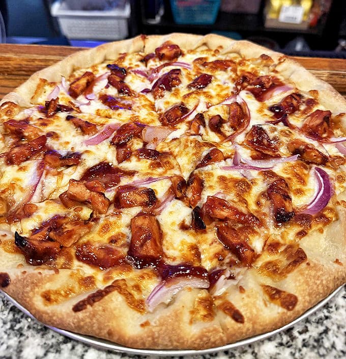 BBQ chicken pizza with its perfect balance of tangy sauce, melted cheese, and red onions proves Gasoline Alley isn't just about sandwiches.