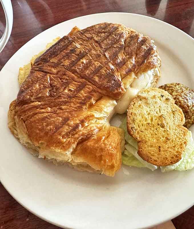 Ham and cheese find their perfect home in this croissant, where savory meets buttery in a handheld masterpiece of culinary engineering.