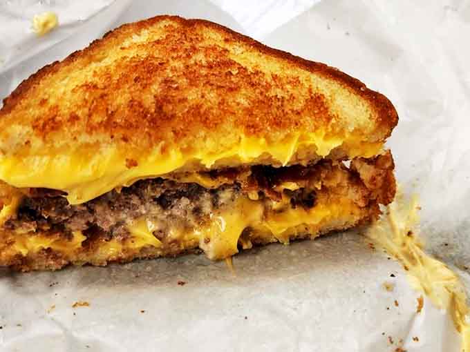 This isn't just a burger, it's a towering achievement of beef, cheese, and toppings that requires both hands and a strategy.