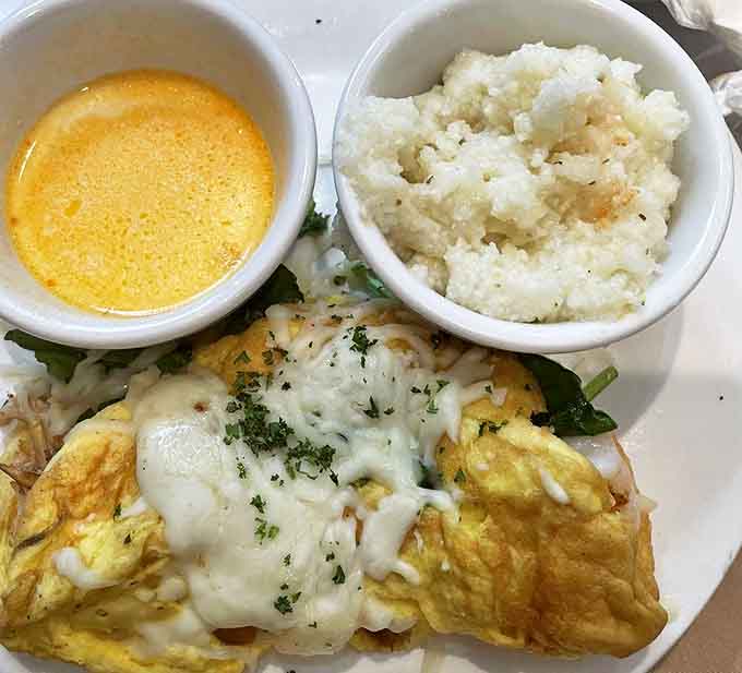 This seafood omelet doesn't just break fast, it breaks expectations &ndash; fluffy eggs cradling seafood treasures alongside grits that would make grandma proud.