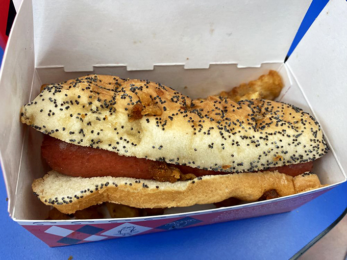 Poppy seed bun cradles this all-beef beauty, while pickle spears and sport peppers stand at attention alongside.