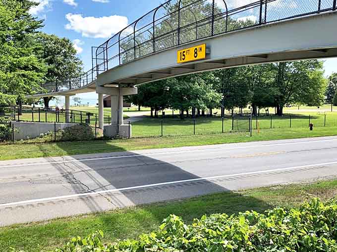 The park's iconic bridge stands as a gateway between worlds &ndash; from everyday concerns to the natural sanctuary beyond.