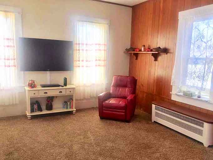 Wood paneling creates a cocoon of warmth around modern comforts &ndash; that leather recliner practically begs you to sink in with a good book.