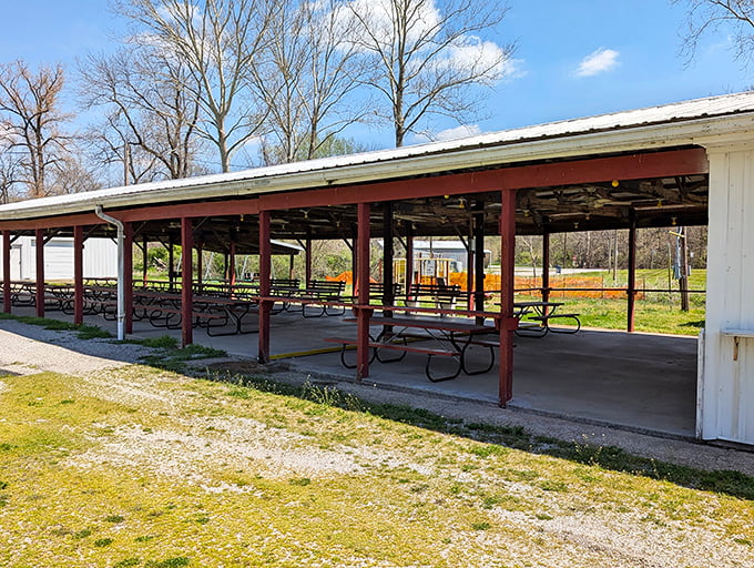 The village park's covered pavilion stands ready for community gatherings &ndash; picnic tables waiting for the next potluck or family reunion.