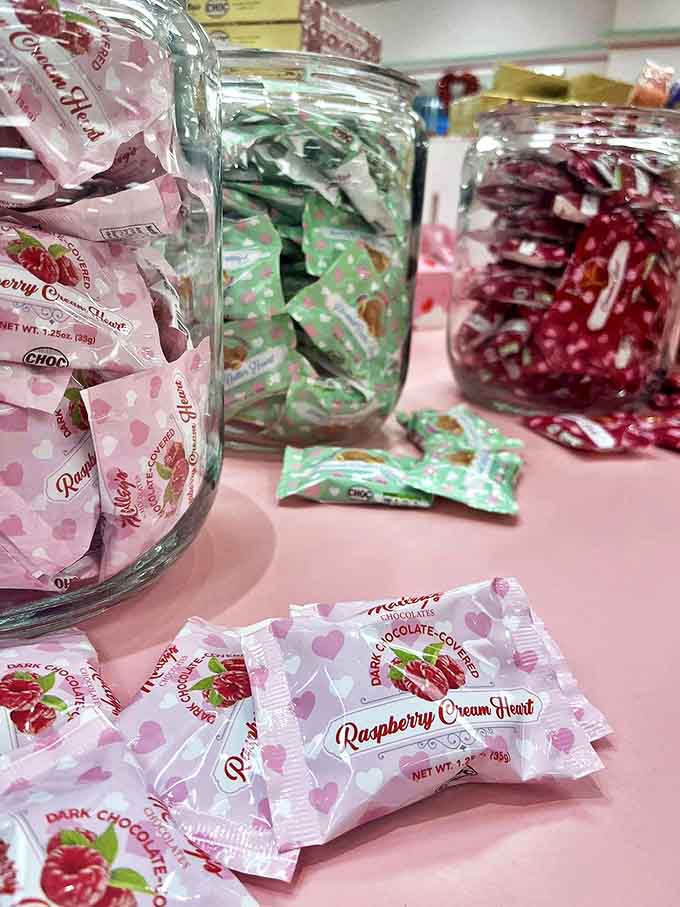 Mason jars filled with colorful wrapped treats create a rainbow of temptation – each tiny package a promise of flavor adventures.