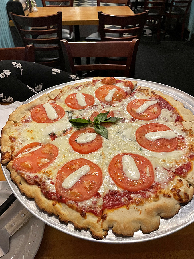 Fresh tomatoes, creamy mozzarella, and aromatic basil make this Margherita pizza a vibrant celebration of classic flavors that would make any Italian grandmother nod in approval.