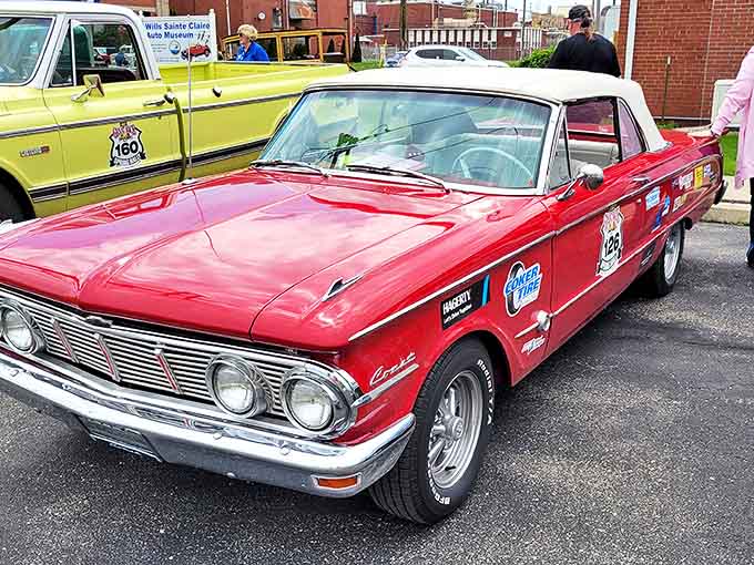 The Mercury Comet S-22 convertible gleams in candy-apple red, ready to transport you back to cruising main streets in the swinging sixties.