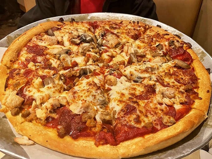 A New York-style pizza that would make even the most skeptical Manhattan cabbie nod in approval – thin, foldable, and absolutely loaded with toppings.