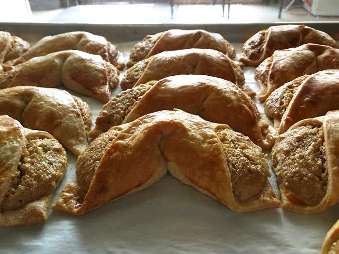 Golden-brown crescents revealing their secrets – the walnut filling peeking out just enough to make your mouth water instantly.