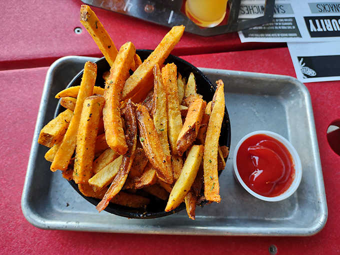 Golden potato batons dusted with secret spices stand at attention in their cast iron vessel, practically begging for a beer pairing.