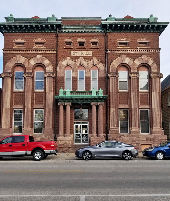 The old City Hall building stands proudly in brick-and-mortar dignity, its green-trimmed cornice a distinctive crown atop this civic treasure.