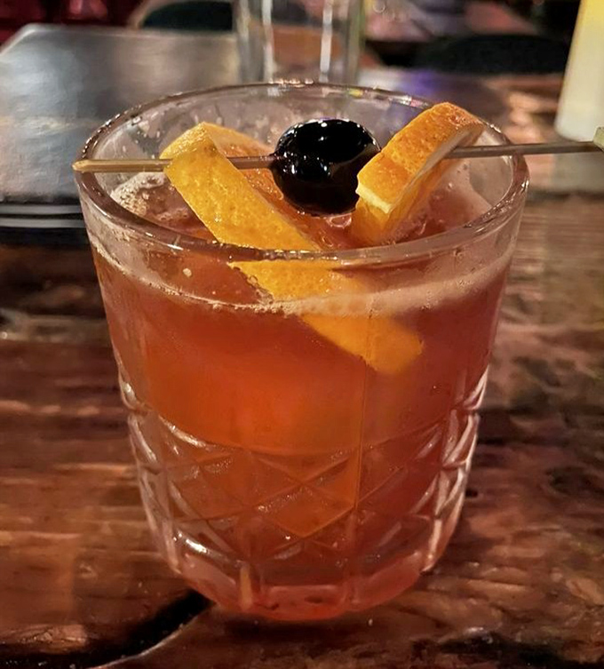 An Old Fashioned that would make Don Draper weep with joy – orange peel and cherry nestled in crystal-clear ice.