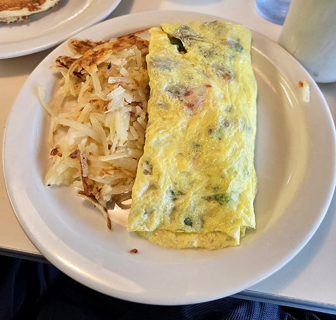 A fluffy egg masterpiece paired with those crispy-outside, tender-inside potatoes that justify getting out of bed.