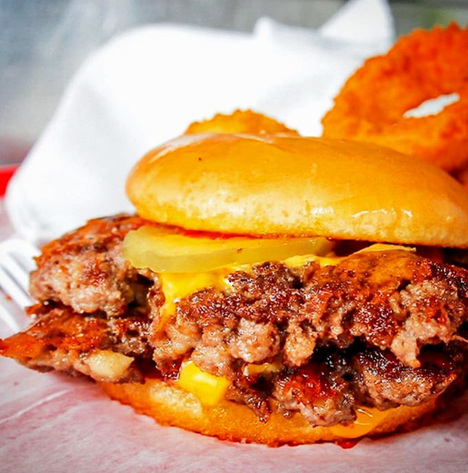 A monument to American abundance &ndash; this cheese-draped behemoth requires commitment, napkins, and possibly a post-meal nap.