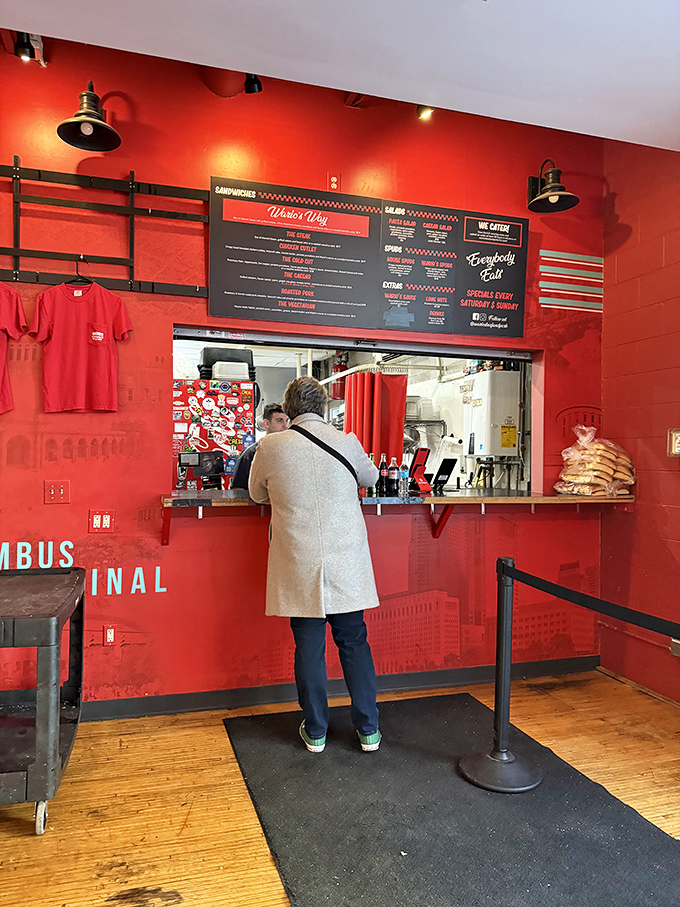 Order Window: The moment of truth arrives at this red-walled sanctuary where sandwich dreams come to life.