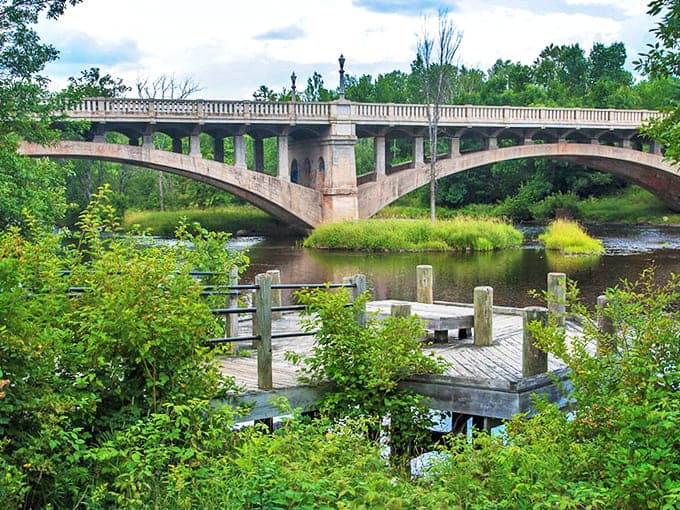 The Paint River Bridge arches gracefully over calm waters, creating a scene so picturesque you'll swear it was designed for postcards.