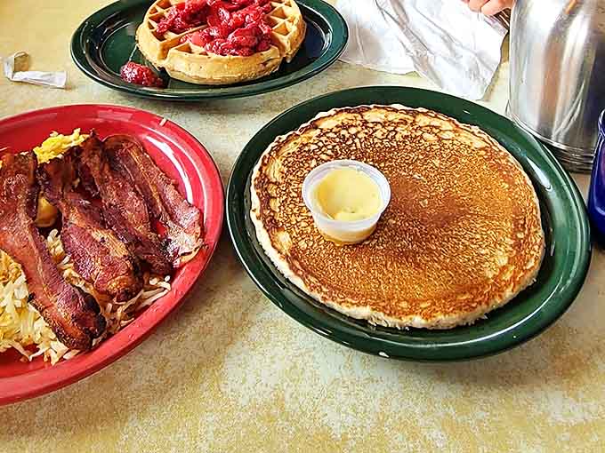 Breakfast harmony on display: crispy bacon, golden hash browns, and a pancake so large it deserves its own zip code.