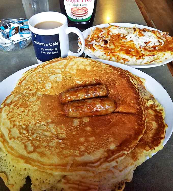 Pancakes so fluffy they practically hover above the plate, with sausage links standing guard against anyone who might try to steal a bite.