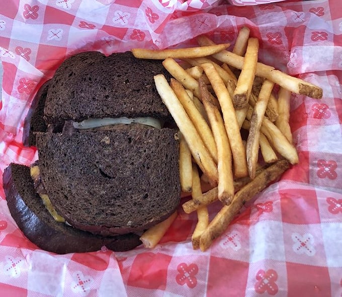 A hearty patty melt with golden fries sits proudly in its basket, the kind of meal that makes you forget the salad you promised yourself and remember why comfort food became a legend in the first place.
