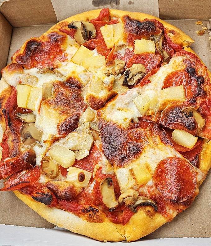 Hawaiian pizza done right &ndash; where pineapple and pepperoni negotiate a delicious peace treaty under the watchful eye of perfectly melted cheese.