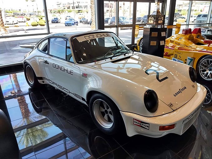 The classic white Porsche 911 "Donohue" edition stands as a testament to Team Penske's versatility beyond oval tracks and into road racing glory.