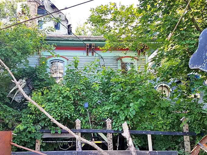 Young visitors peer through a yellow-framed opening, their expressions a mix of curiosity and delight.