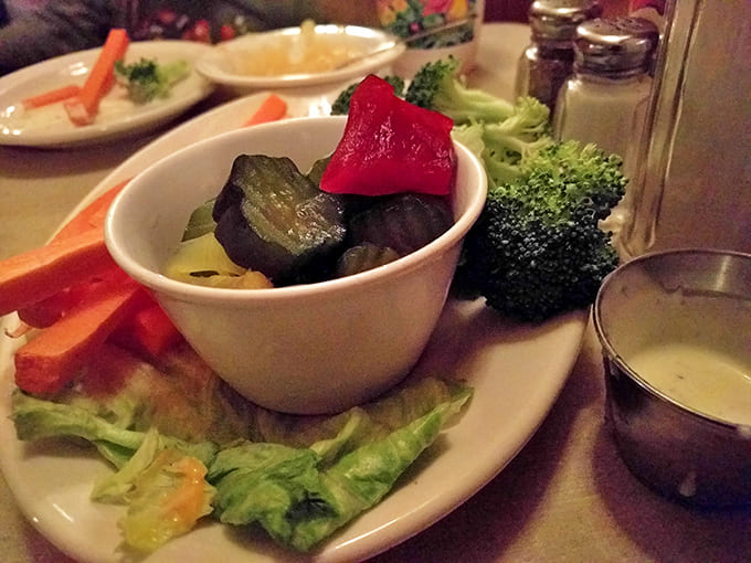 A refreshing throwback to when vegetables were served with pride, not apology. Crisp broccoli and carrots surround tangy pickles on a bed of fresh lettuce.