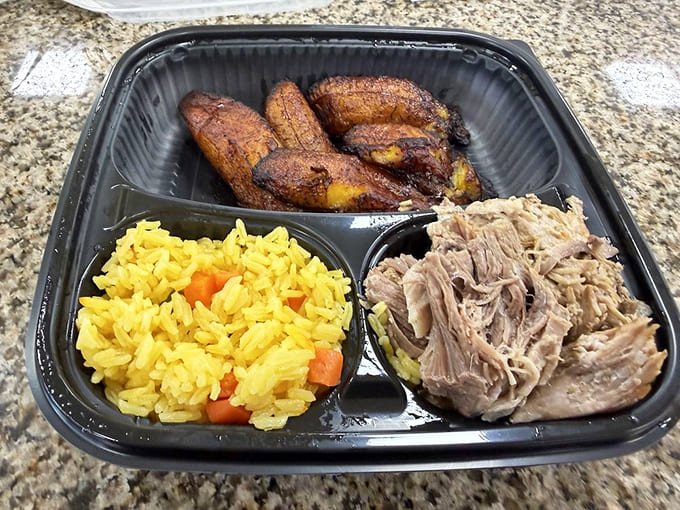 Roast pork with rice and sweet plantains, a complete meal that showcases authentic flavors done right.