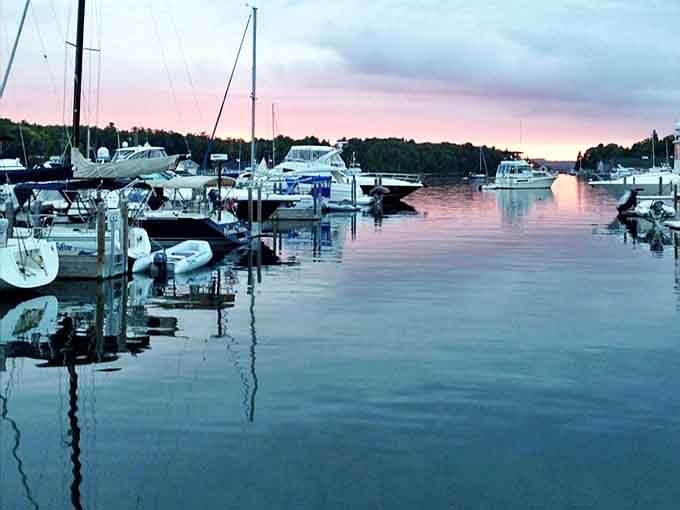 Twilight transforms Charlevoix's marina into a painting of pastels and silhouettes, where boats rest after a day of adventure.