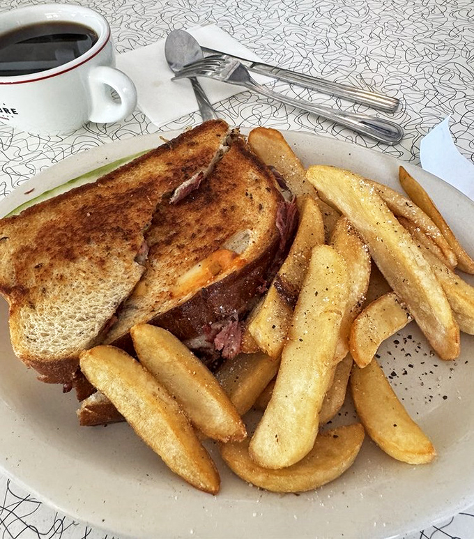 A perfectly executed diner classic: the grilled sandwich with golden-brown bread, melty cheese, and crispy fries that keep locals coming back.