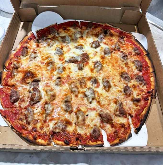 The sausage and garlic pizza delivers a one-two punch of flavor that's kept locals coming back for generations.