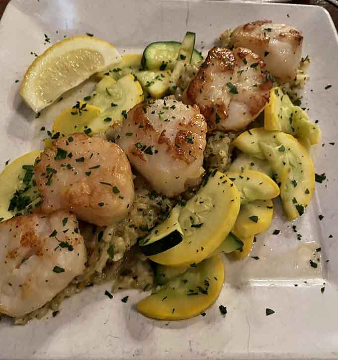 Seared scallops nestled among summer squash and zucchini &ndash; proof that Pickwick's talents extend well beyond beef into the treasures of the sea.